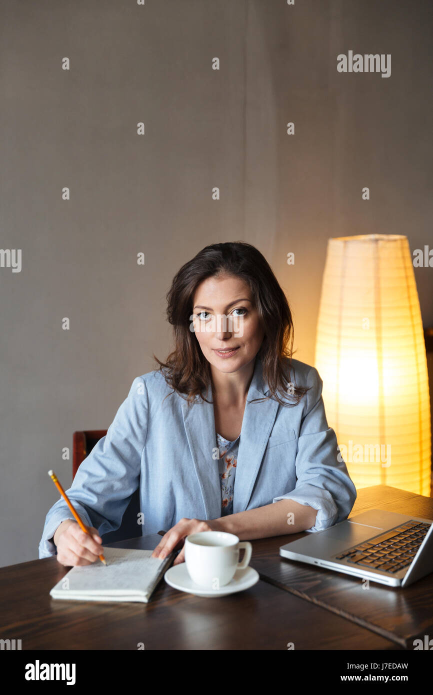 Picture of thinking woman writer sitting indoors using laptop computer ...