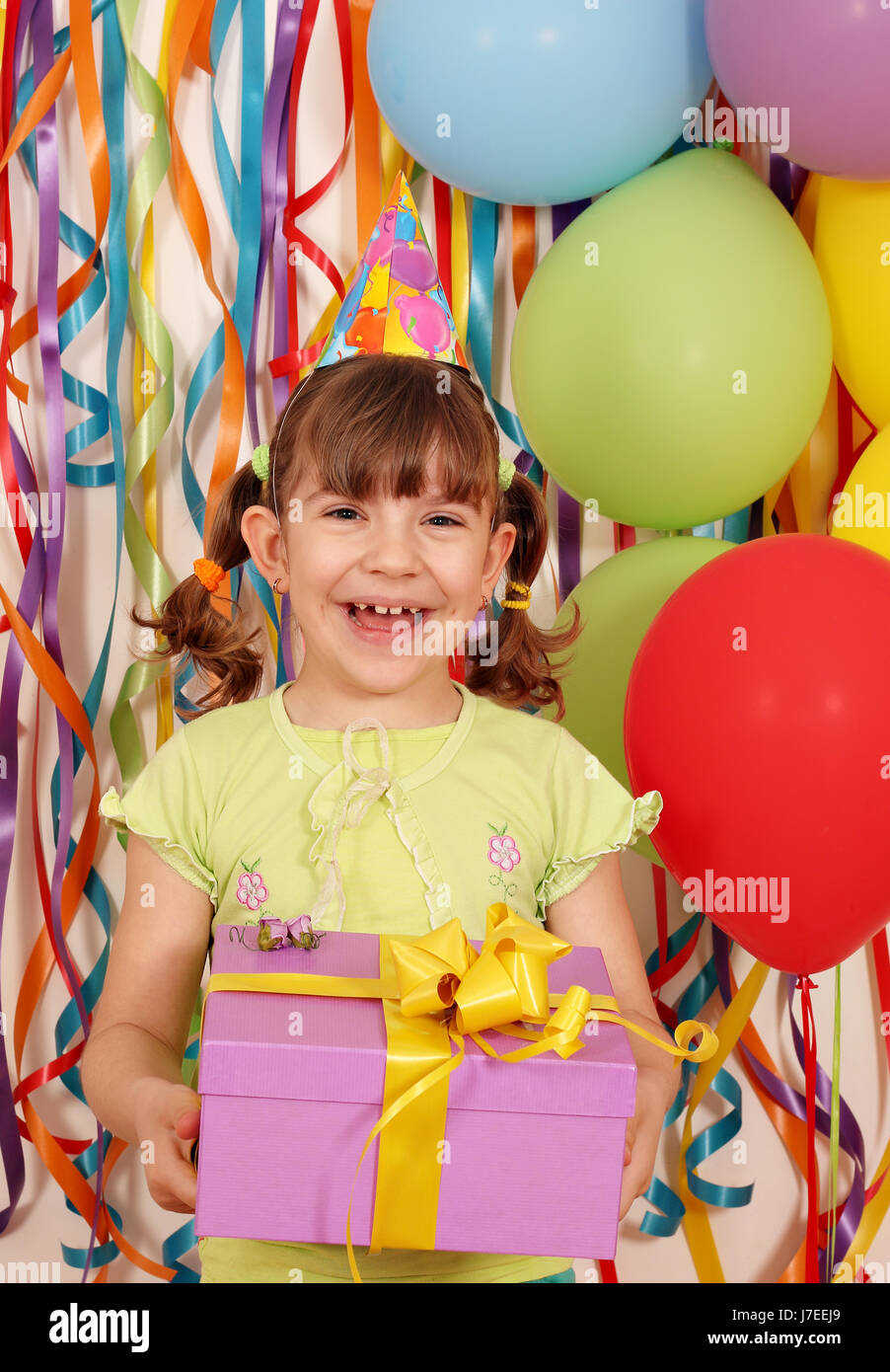 happy little girl with gift birthday party Stock Photo - Alamy