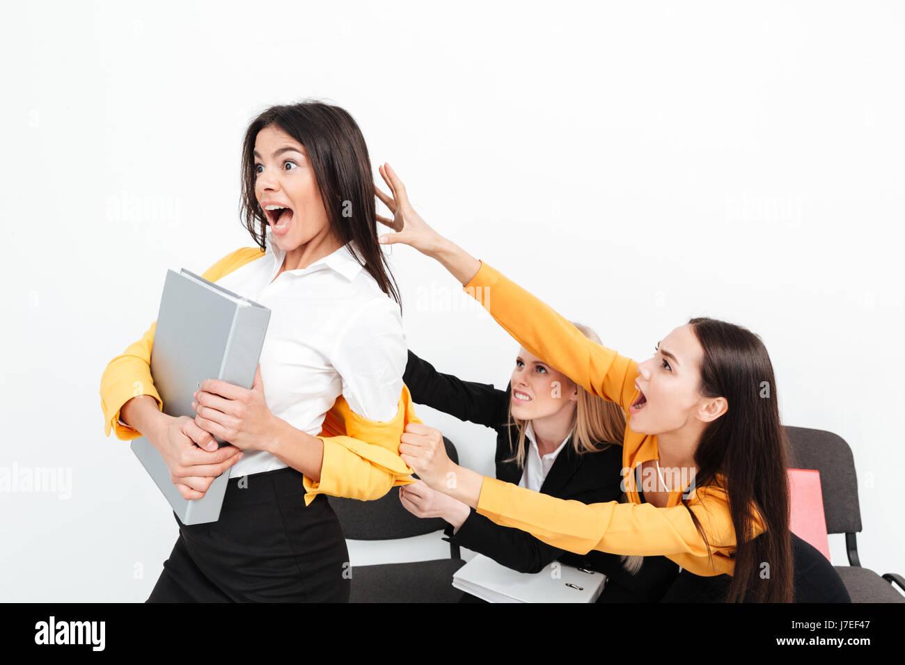 Photo of a group of screaming colleagues women in office. Looking aside ...