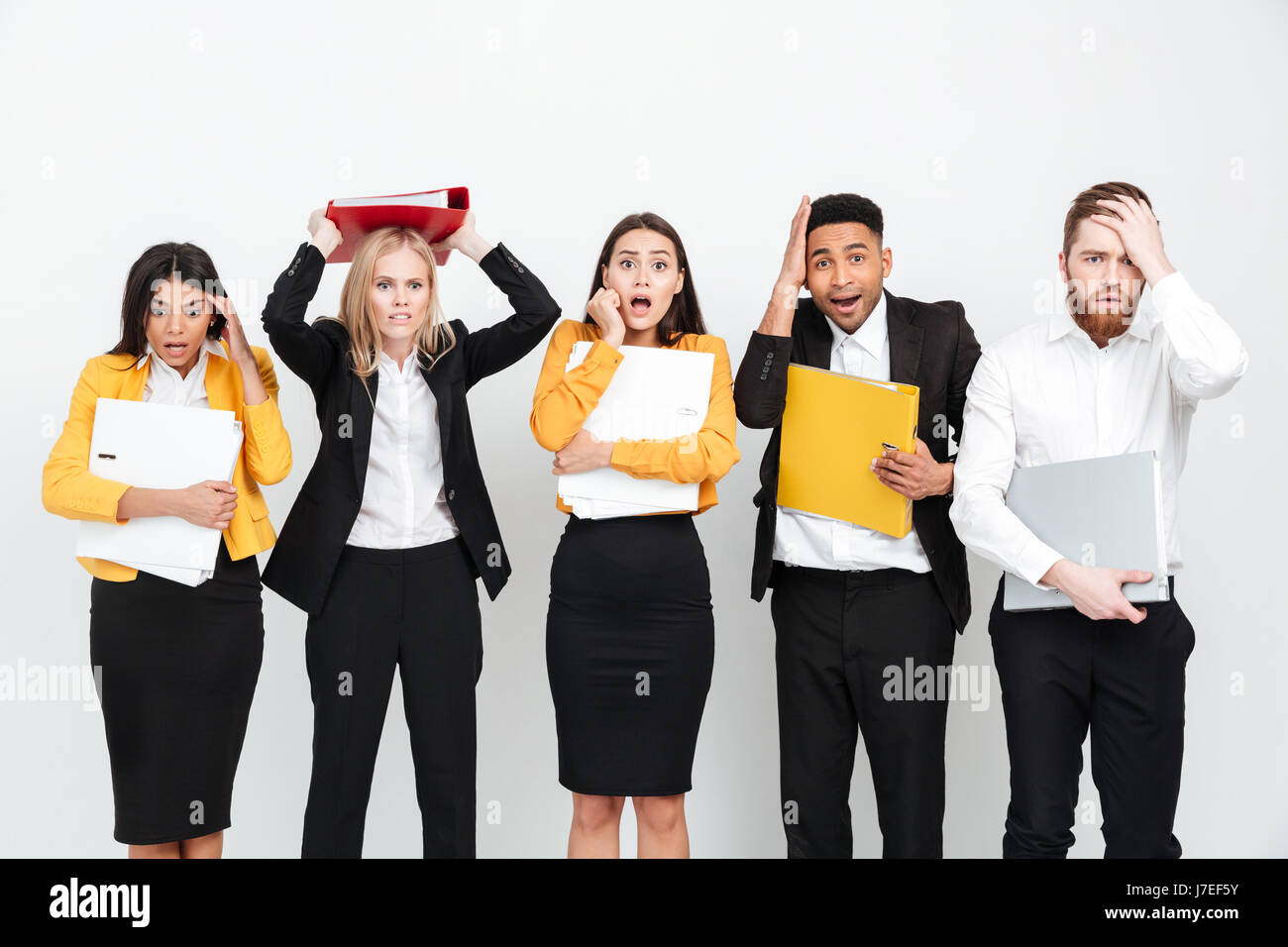 Image of shocked group of colleagues standing isolated in office ...