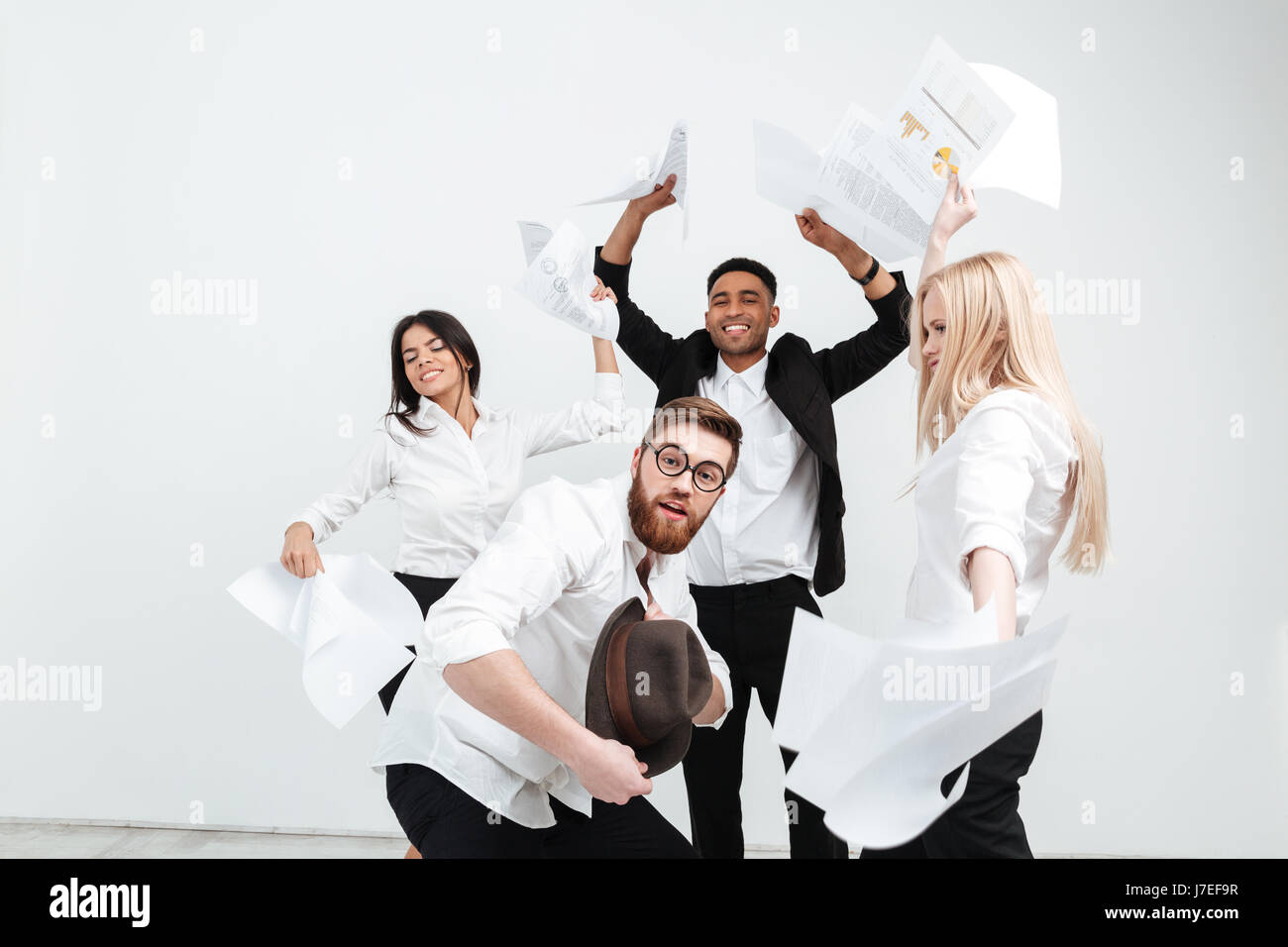 Image of a group of happy colleagues dancing in office. Looking at ...