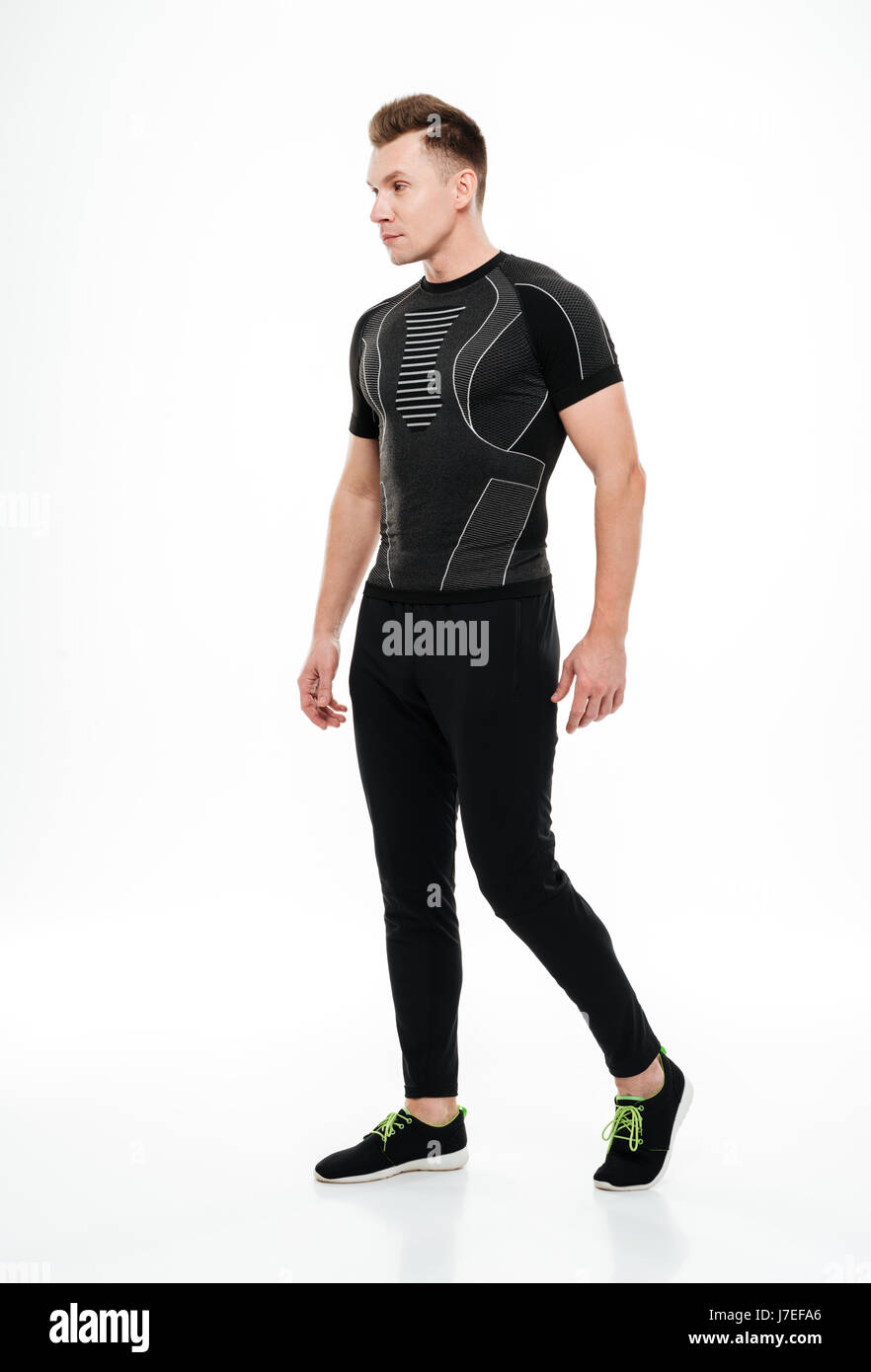 Full length of a young healthy sportsman posing and looking away ...