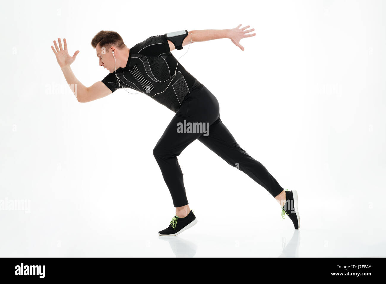 Side view full length portrait of a healthy sportsman started to run ...