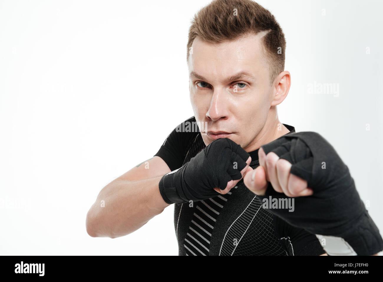 Close up portrait of a healthy fit sportsman boxing isolated over white ...