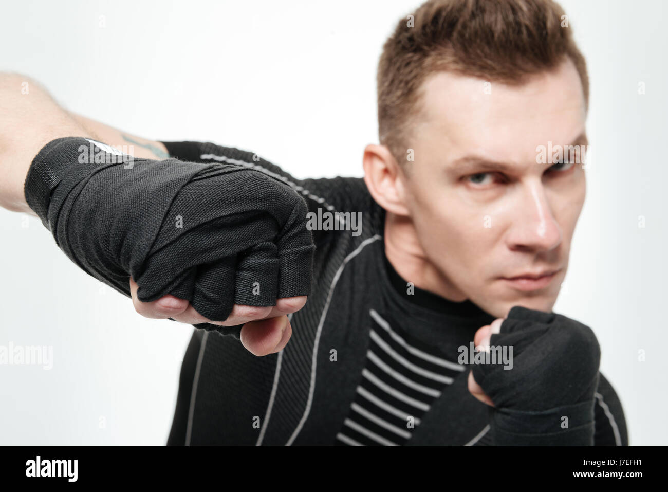 Close up portrait of an angry professional male fighter boxing isolated ...