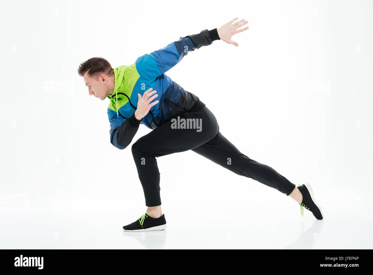 Picture of serious strong sportsman running isolated over white ...