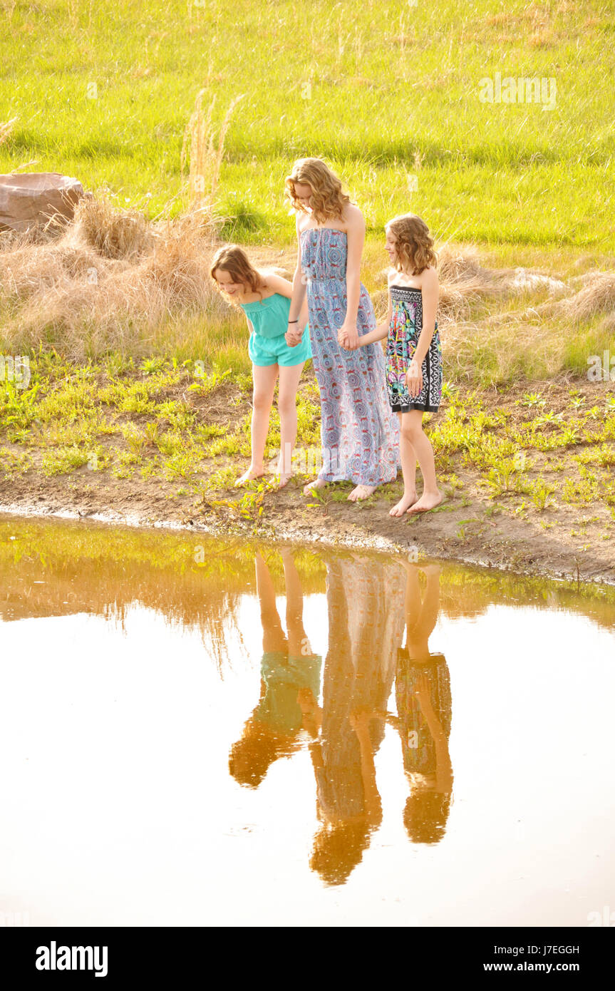 three girls reflection Stock Photo - Alamy