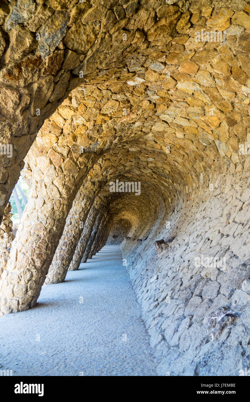 Colonnaded stone pathway in Antoni Gaudi's Park Güell, Barcelona, Spain ...