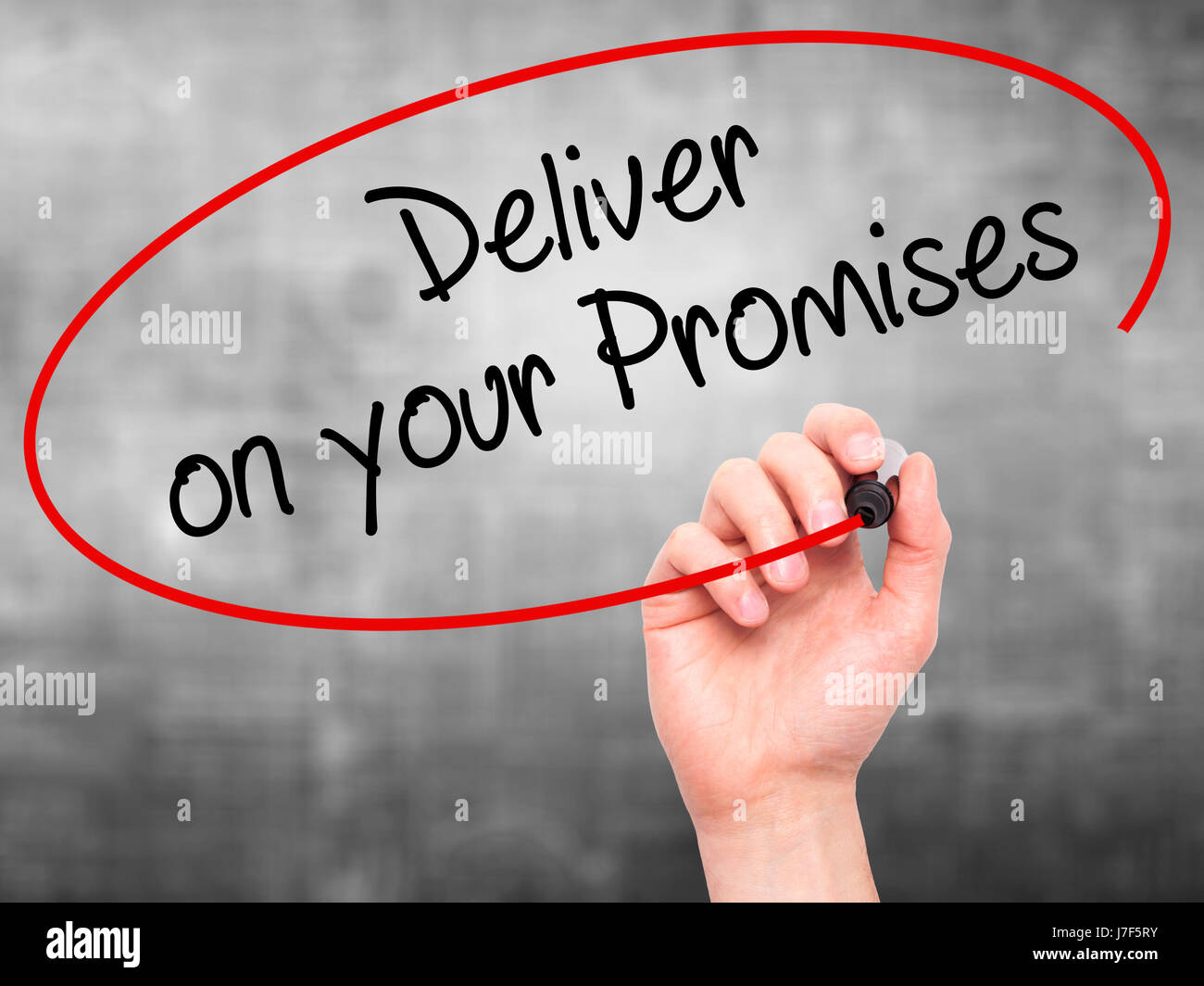Man Hand writing Deliver on your Promises with black marker on visual ...