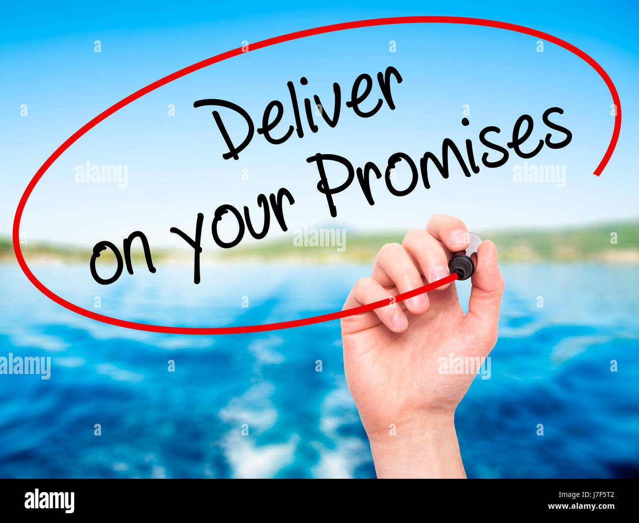 Man Hand writing Deliver on your Promises with black marker on visual ...