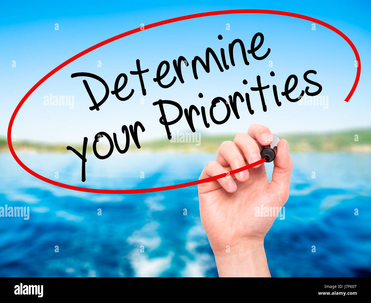 Man Hand writing Determine your Priorities with black marker on visual ...