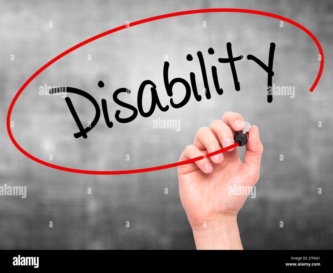 Man Hand writing Disability with black marker on visual screen ...