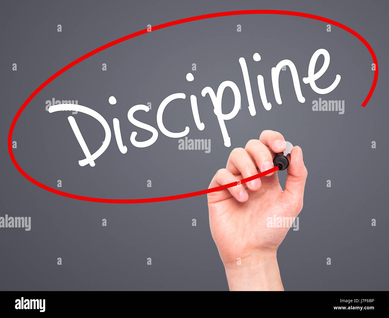 Man Hand writing Discipline with black marker on visual screen ...