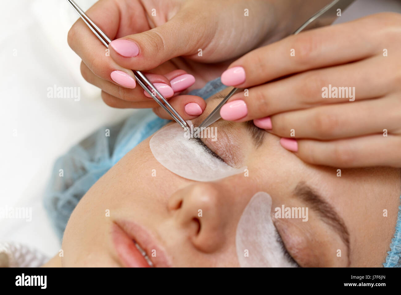 Beauty salon. The procedure of fastening the extended eyelashes ...