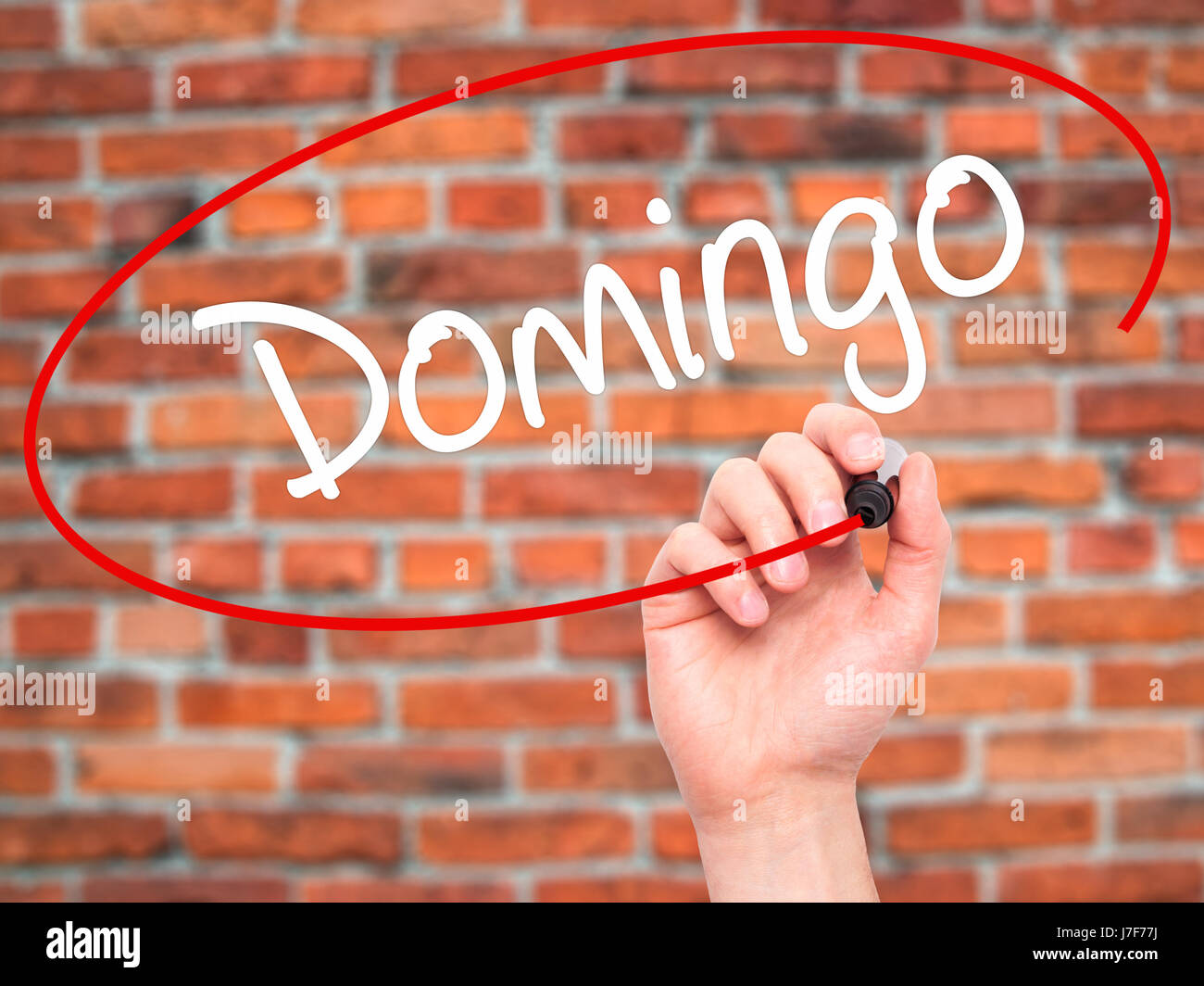 Man Hand writing Domingo (Sunday in Spanish/Portuguese) with black ...