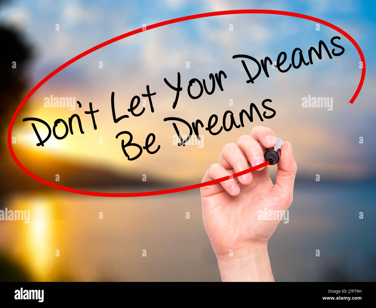 Man Hand writing Don't Let Your Dreams Be Dreams with black marker on ...