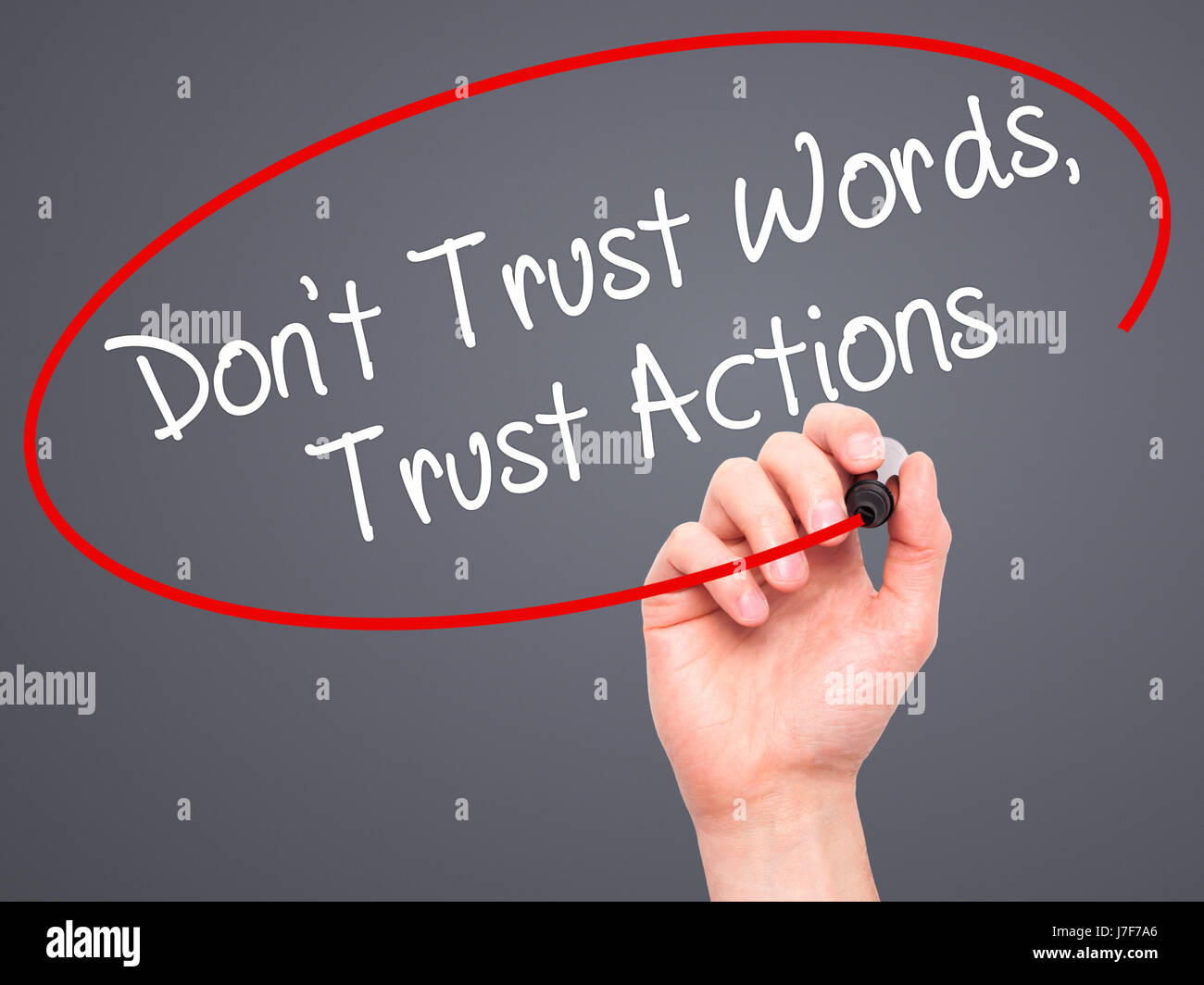 Man Hand writing Don't Trust Words, Trust Actions with black marker on ...