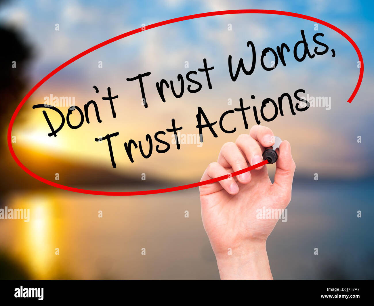 Man Hand writing Don't Trust Words, Trust Actions with black marker on ...