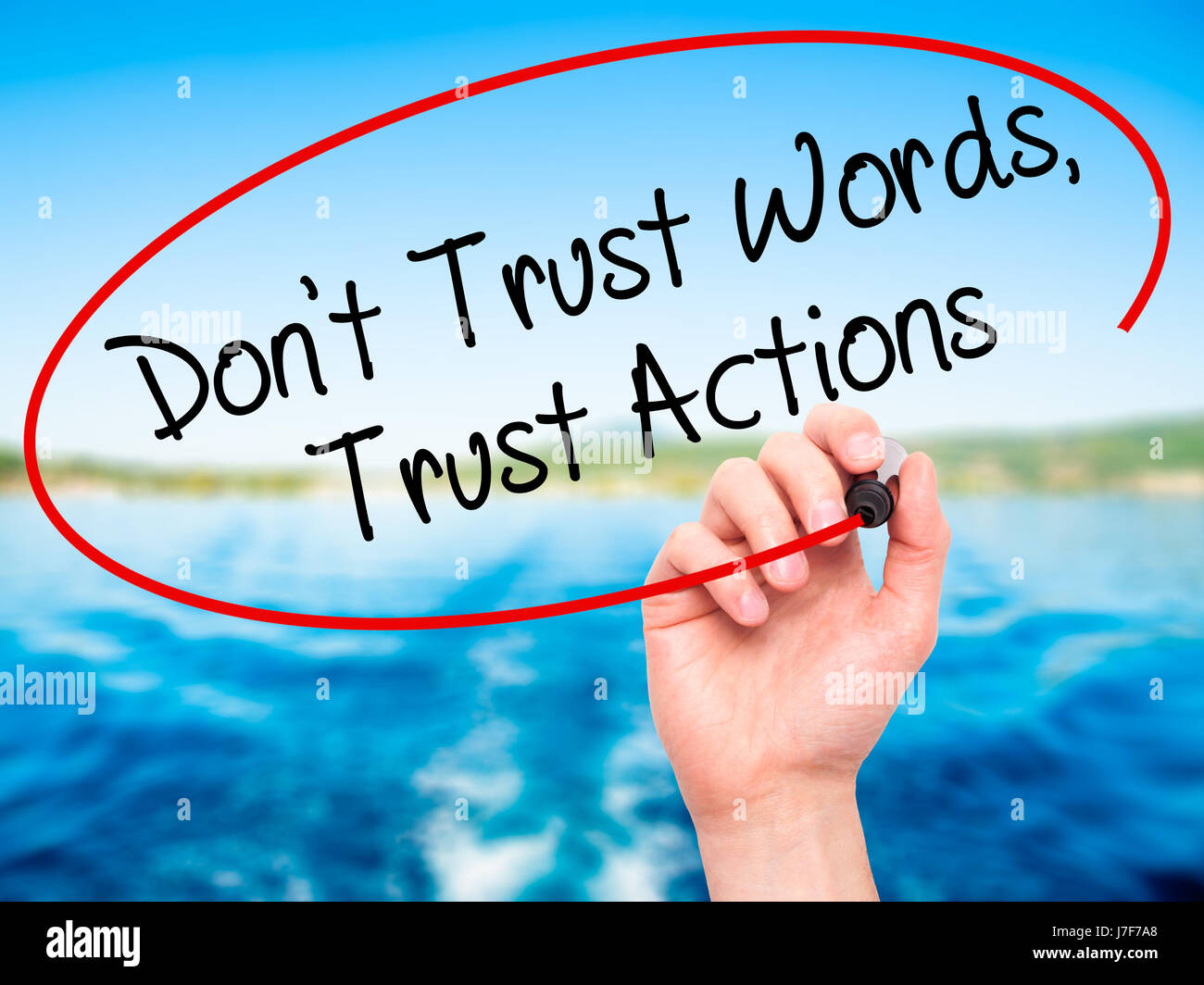 Man Hand writing Don't Trust Words, Trust Actions with black marker on ...