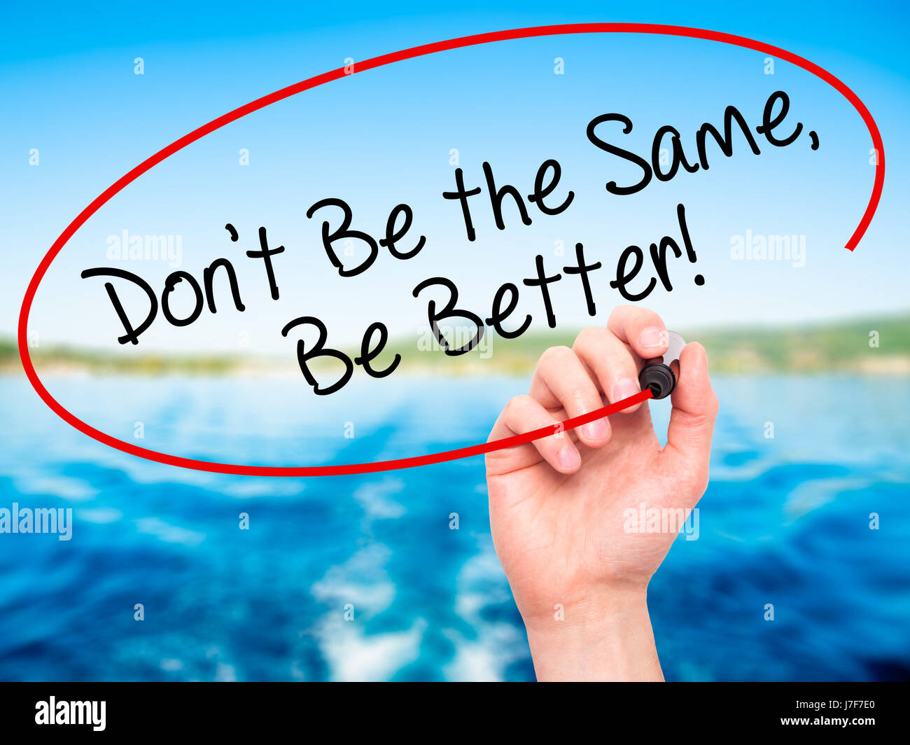 Man Hand writing Don't Be the Same, Be Better! with black marker on ...