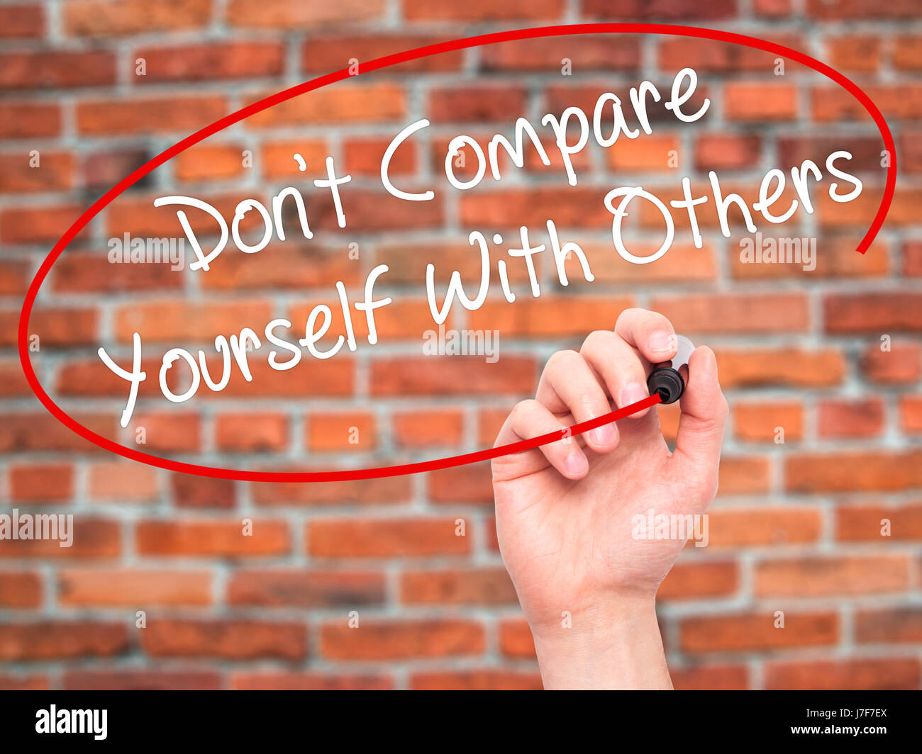 Man Hand writing Don't Compare Yourself With Others with black marker ...