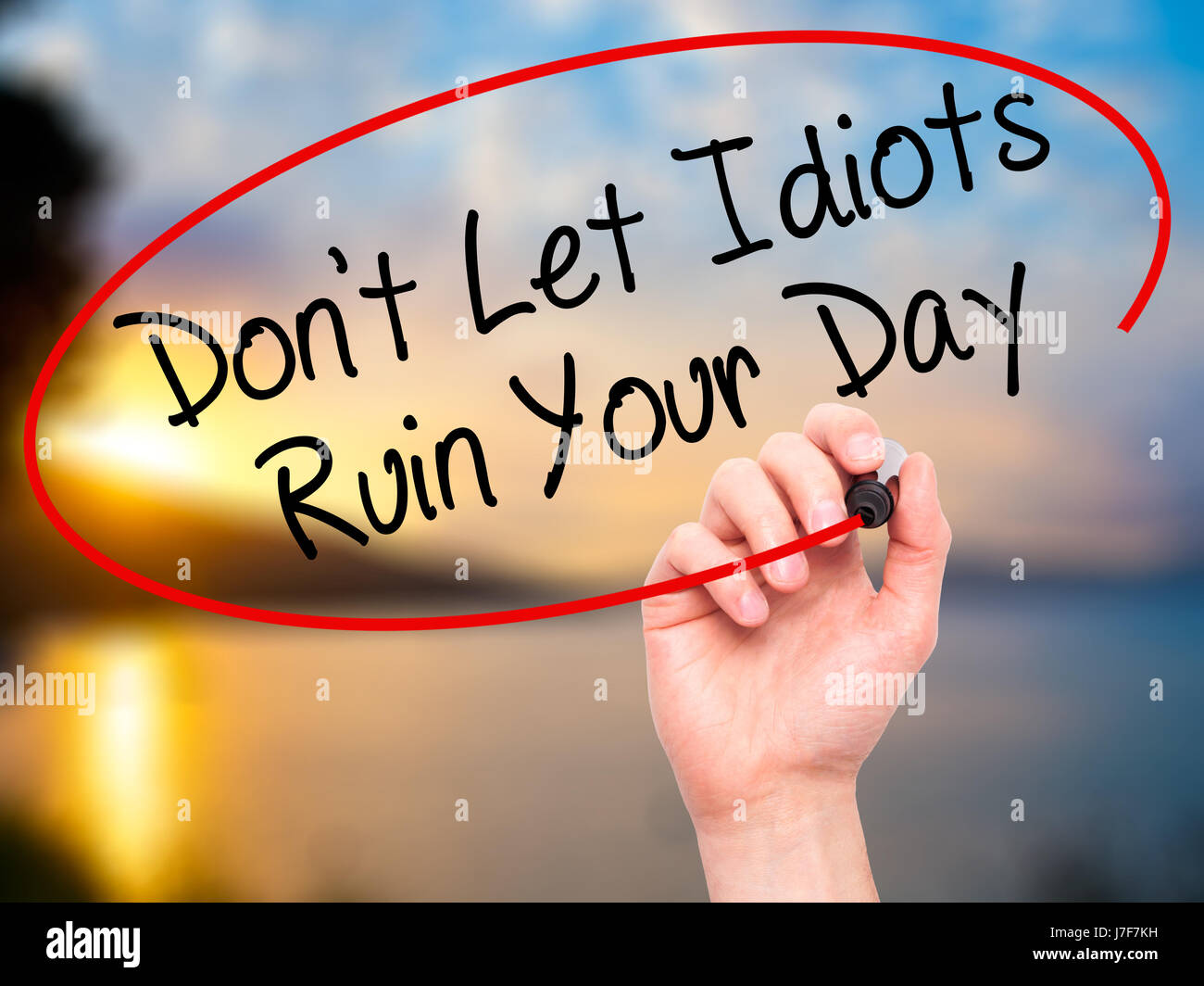 Man Hand writing Don't Let Idiots Ruin Your Day with black marker on ...