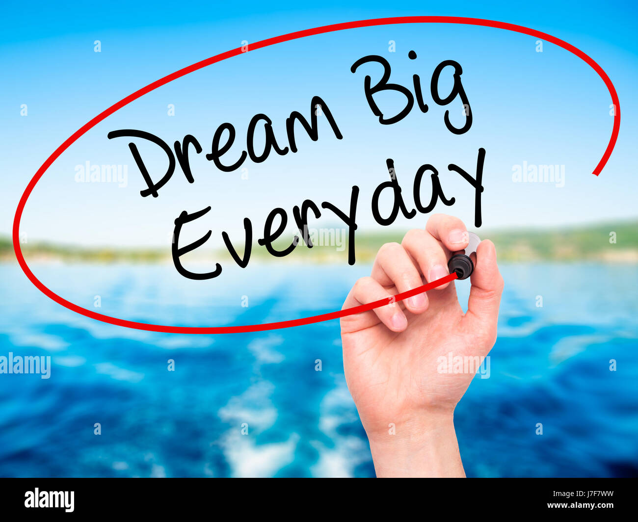 Man Hand writing Dream Big Everyday with black marker on visual screen ...
