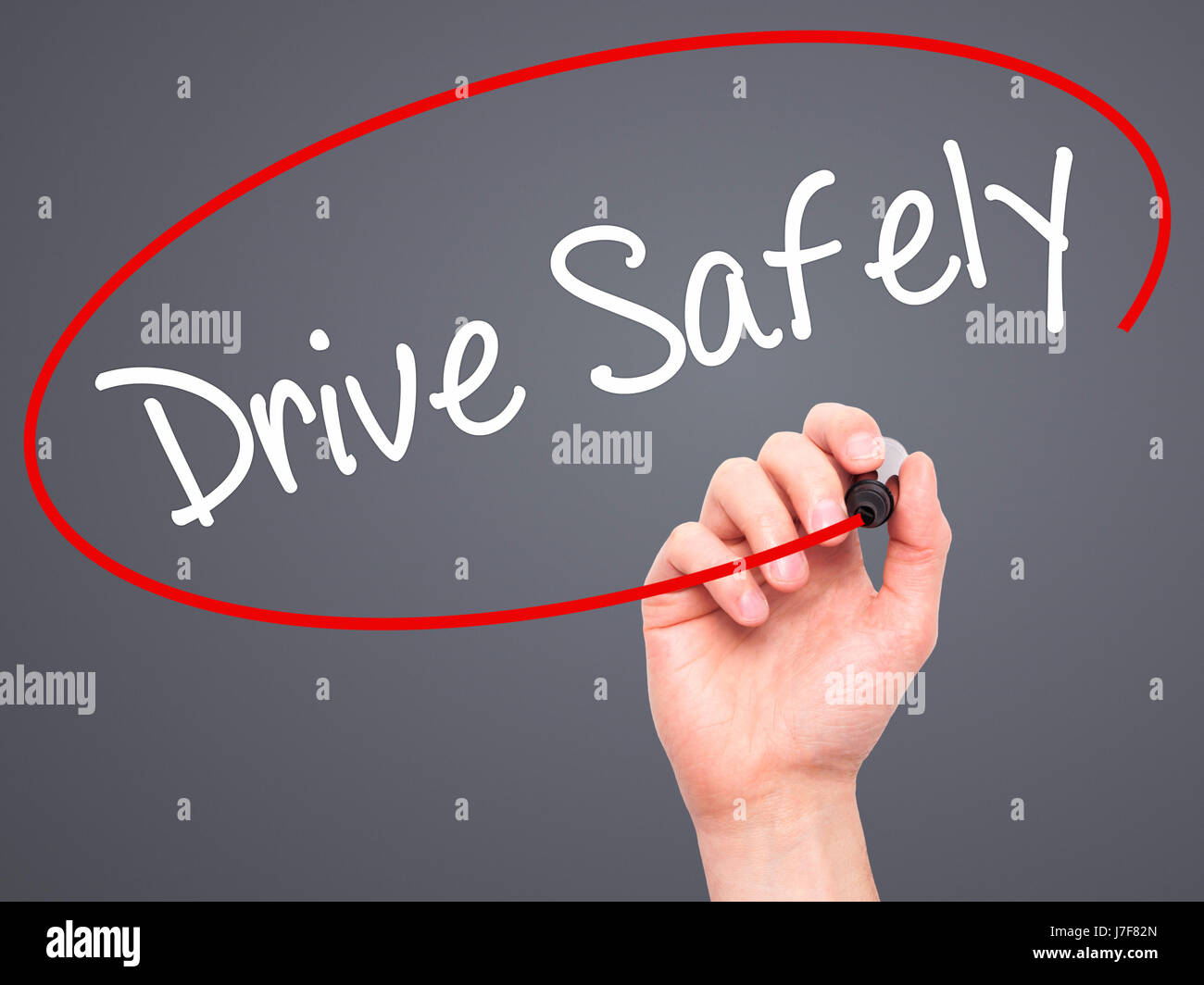 Man Hand writing Drive Safely with black marker on visual screen ...
