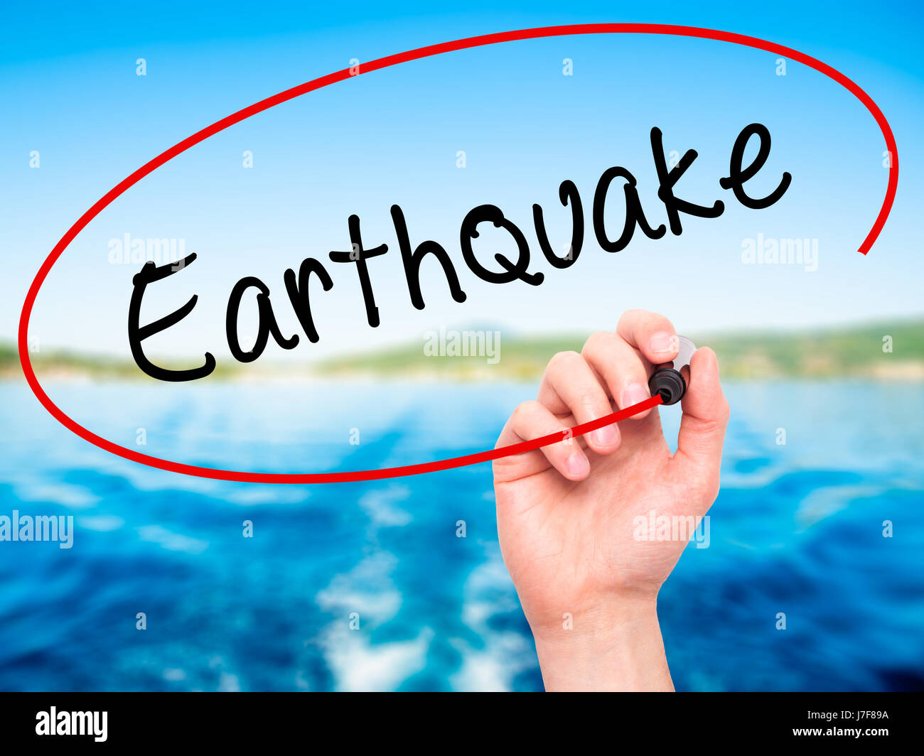 Man Hand writing Earthquake with black marker on visual screen ...