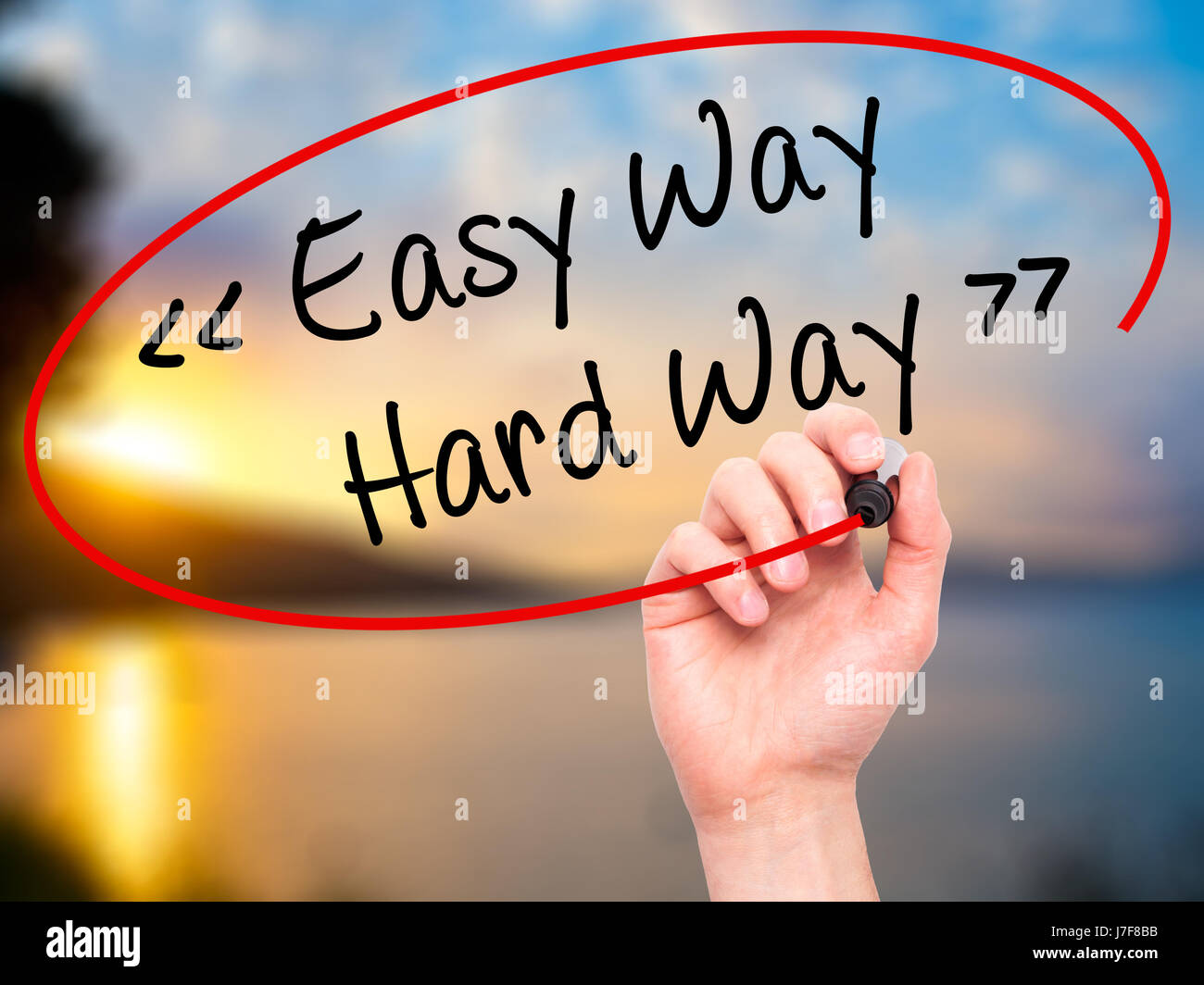 Man Hand writing Easy Way - Hard Way with black marker on visual screen ...