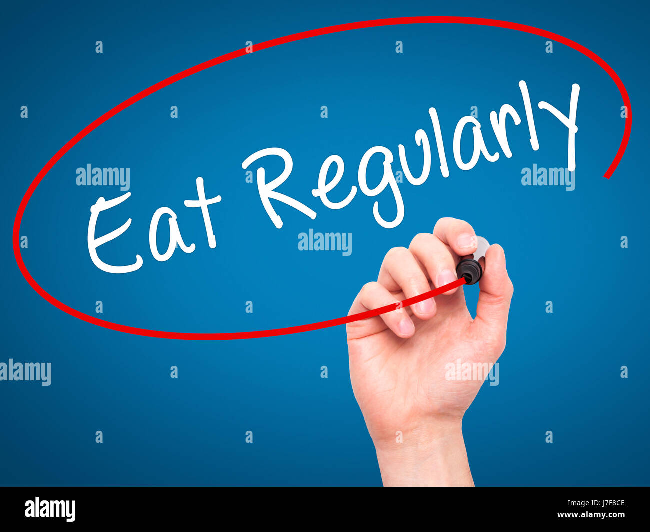 Man Hand writing Eat Regularly with black marker on visual screen ...
