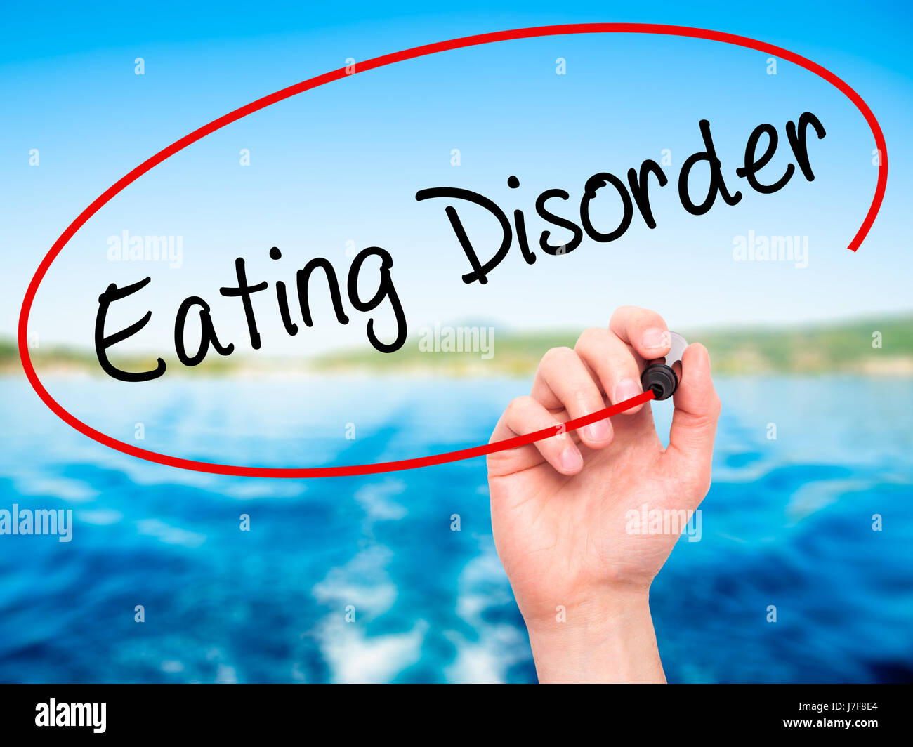 Man Hand writing Eating Disorder with black marker on visual screen ...