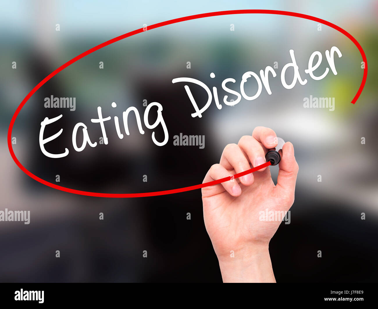 Man Hand writing Eating Disorder with black marker on visual screen ...