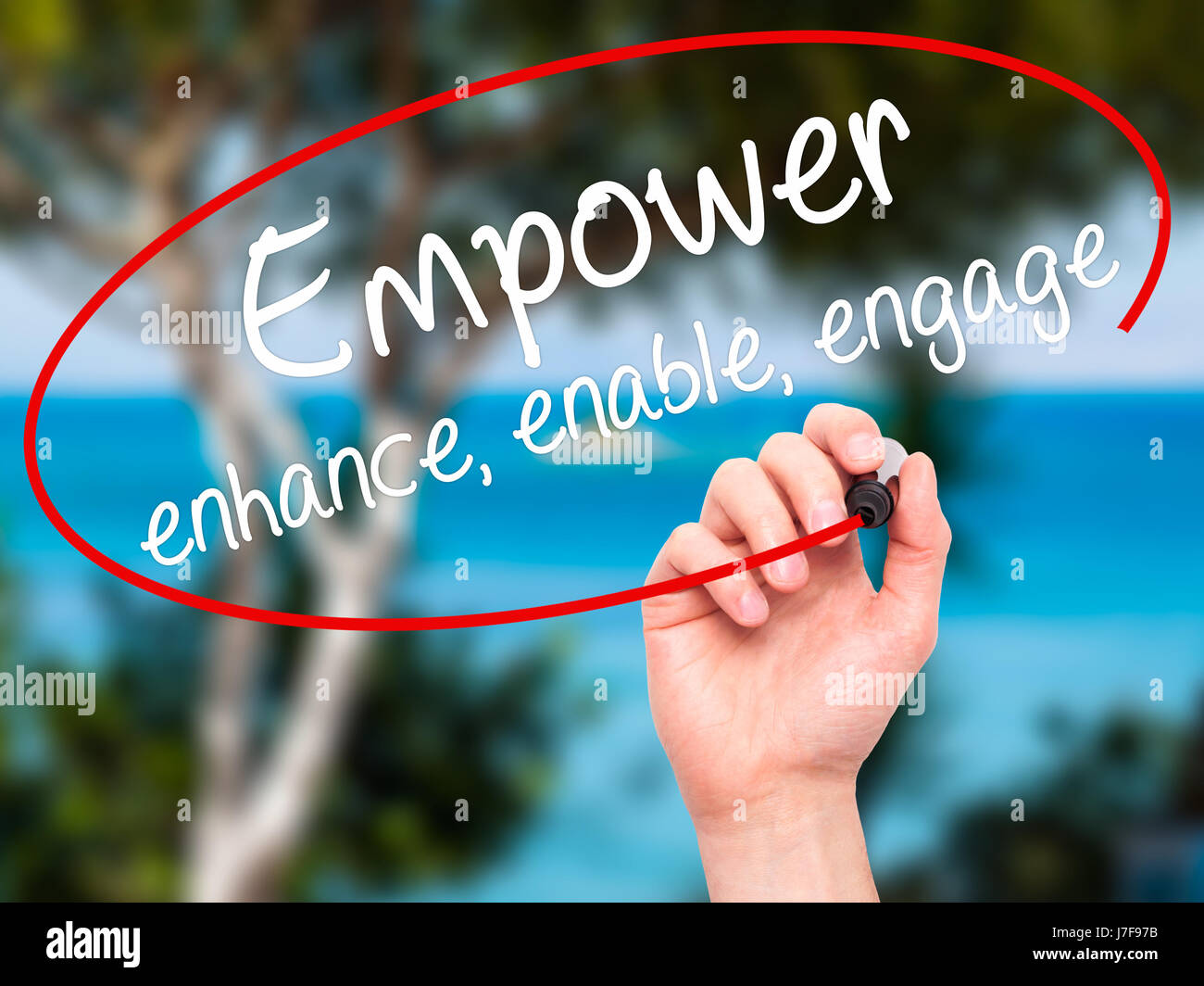 Man Hand writing Empower enhance, enable, engage with black marker on ...