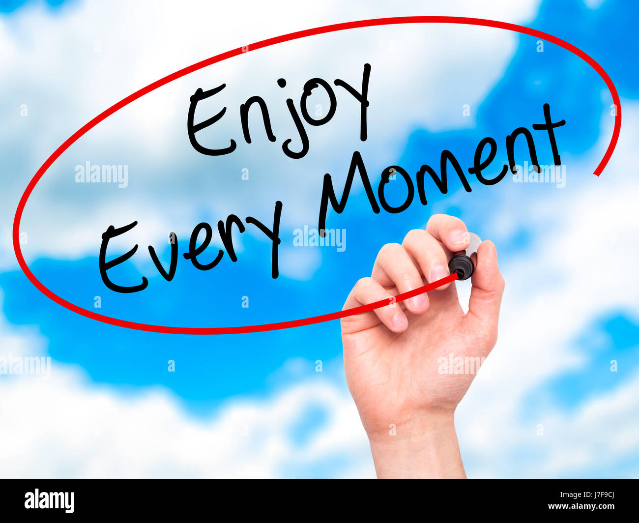 Man Hand writing Enjoy Every Moment with black marker on visual screen ...