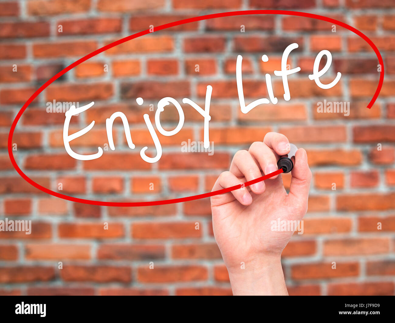 Man Hand writing Enjoy Life with black marker on visual screen ...