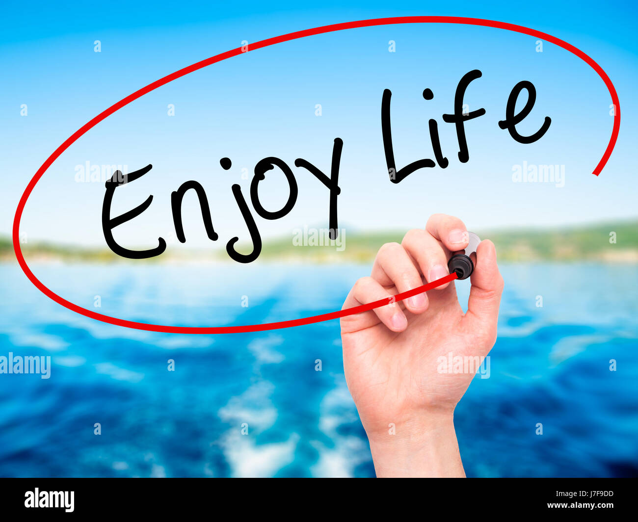 Man Hand writing Enjoy Life with black marker on visual screen ...