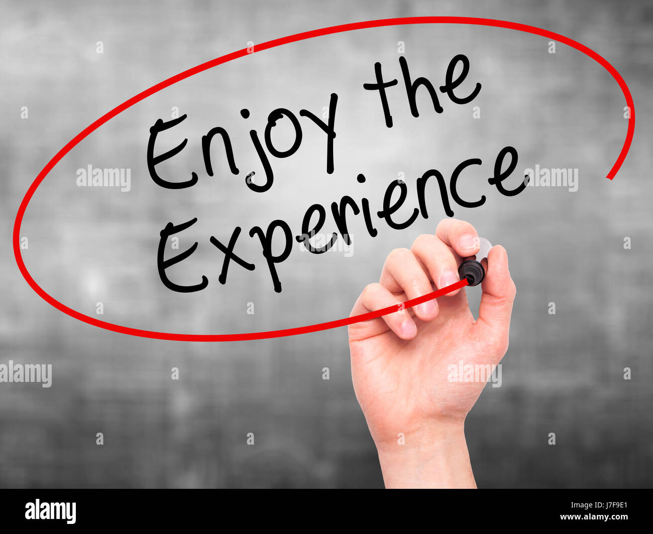 Man Hand writing Enjoy the Experience with black marker on visual ...