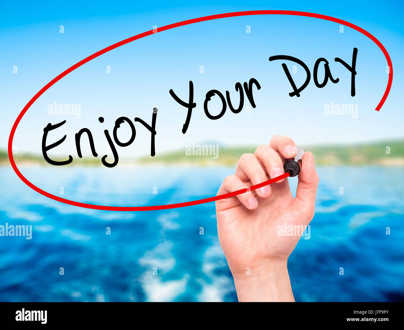 Man Hand writing Enjoy Your Day with black marker on visual screen ...