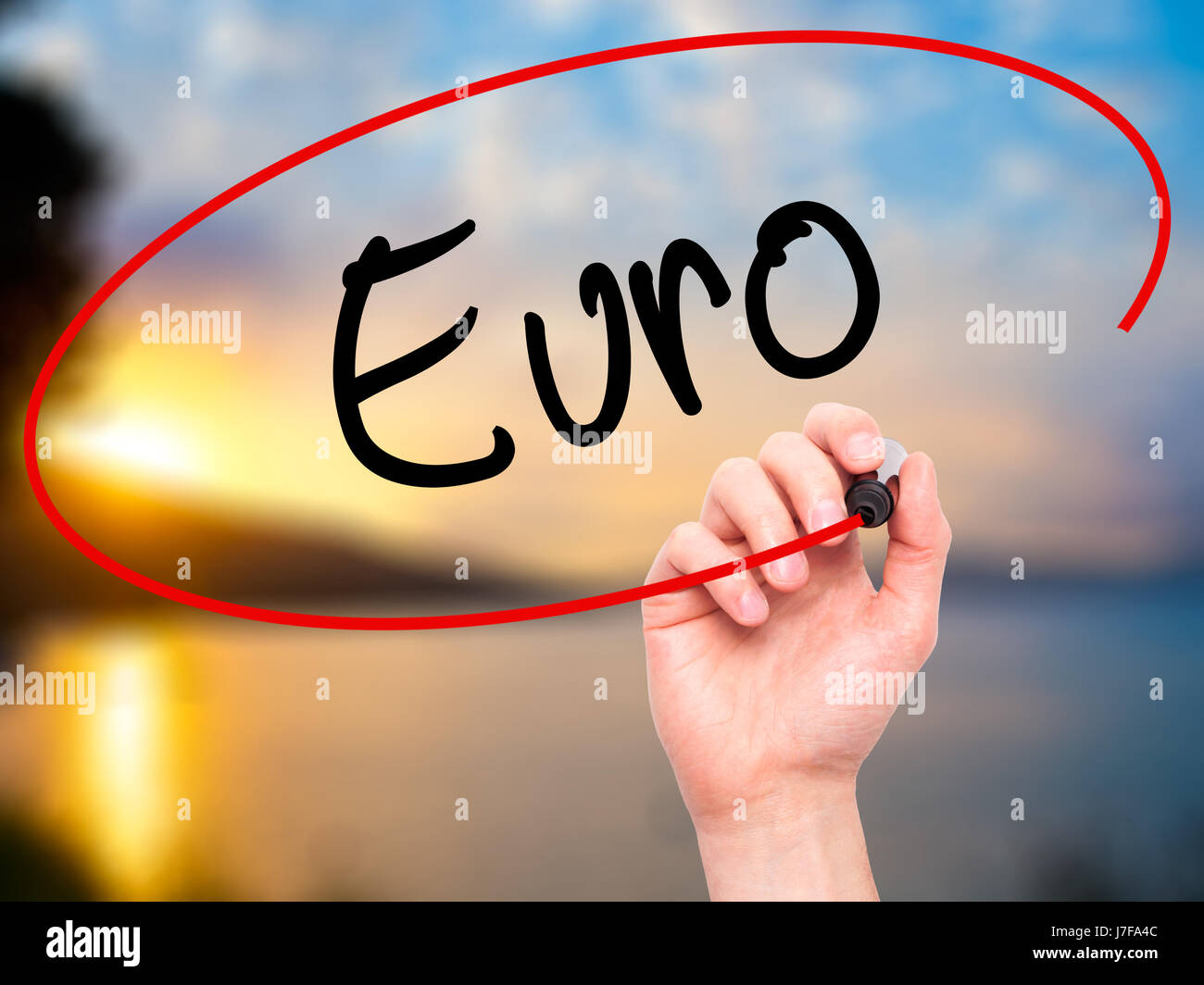 Man Hand writing Euro with black marker on visual screen. Isolated on ...