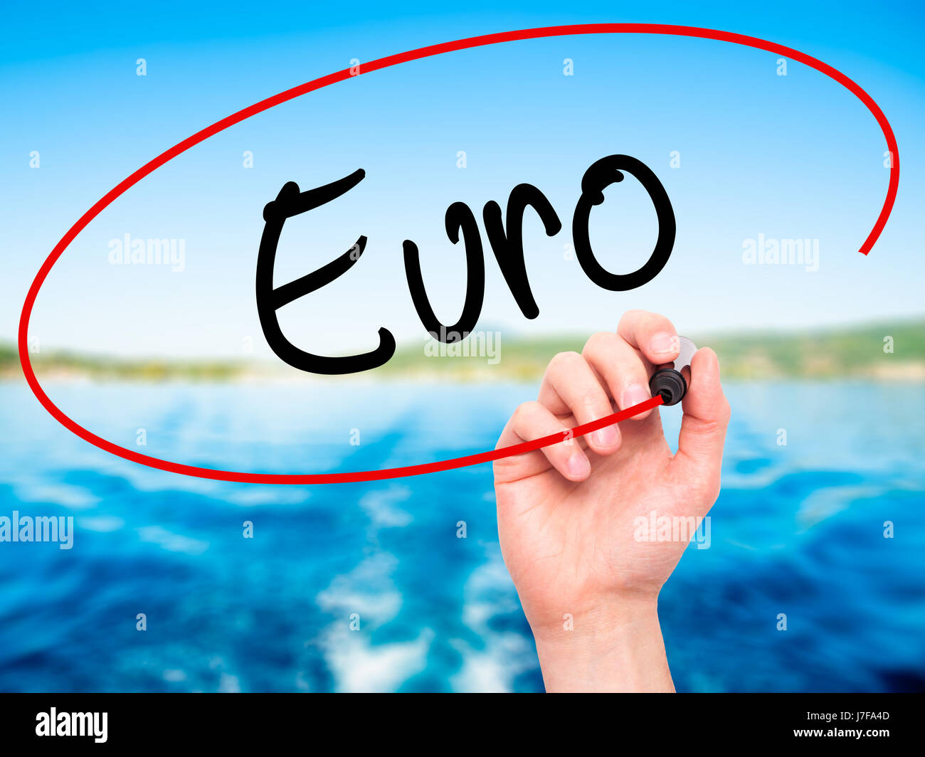 Man Hand writing Euro with black marker on visual screen. Isolated on ...