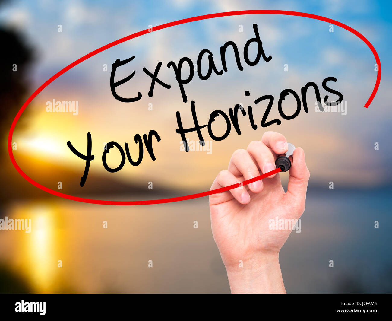 Man Hand writing Expand Your Horizons with black marker on visual ...