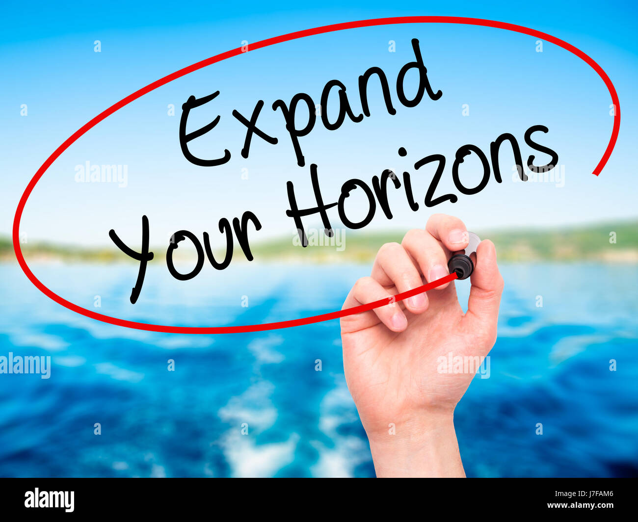 Man Hand writing Expand Your Horizons with black marker on visual ...