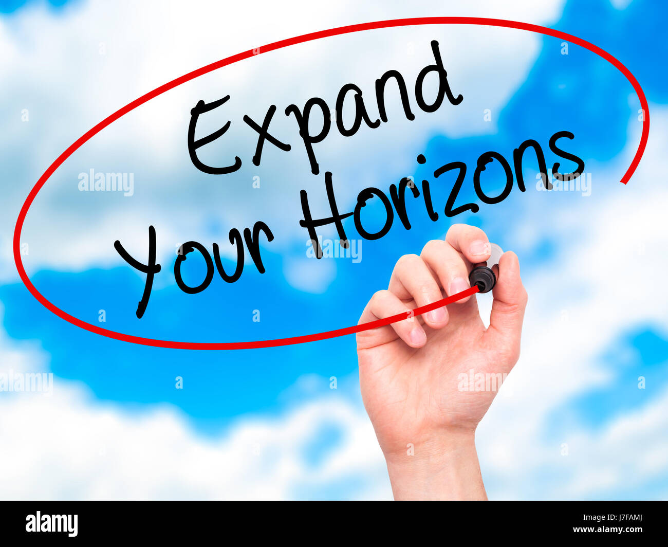 Man Hand writing Expand Your Horizons with black marker on visual ...