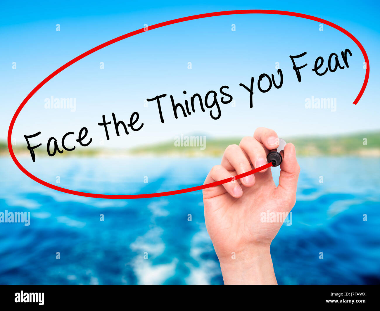 Man Hand writing Face the Things you Fear with black marker on visual ...