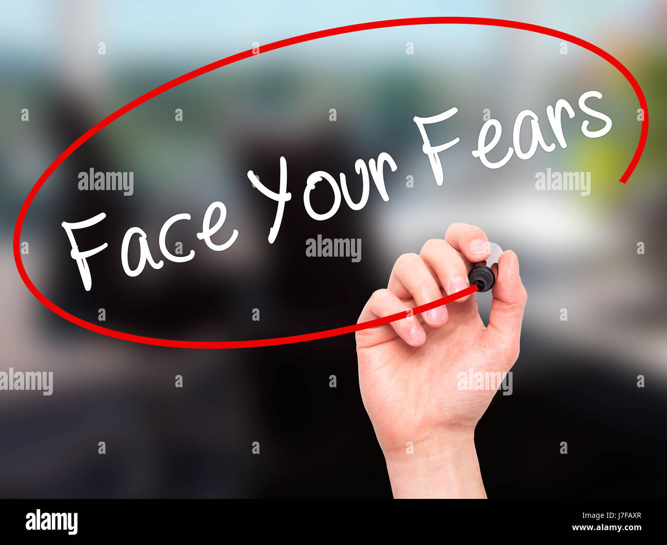 Man Hand writing Face Your Fears with black marker on visual screen ...