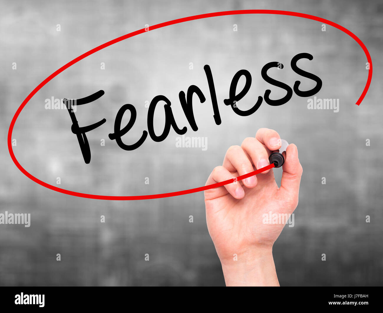 Man Hand writing Fearless with black marker on visual screen. Isolated ...