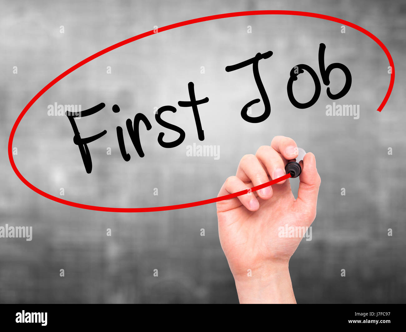Man Hand writing First Job with black marker on visual screen. Isolated ...