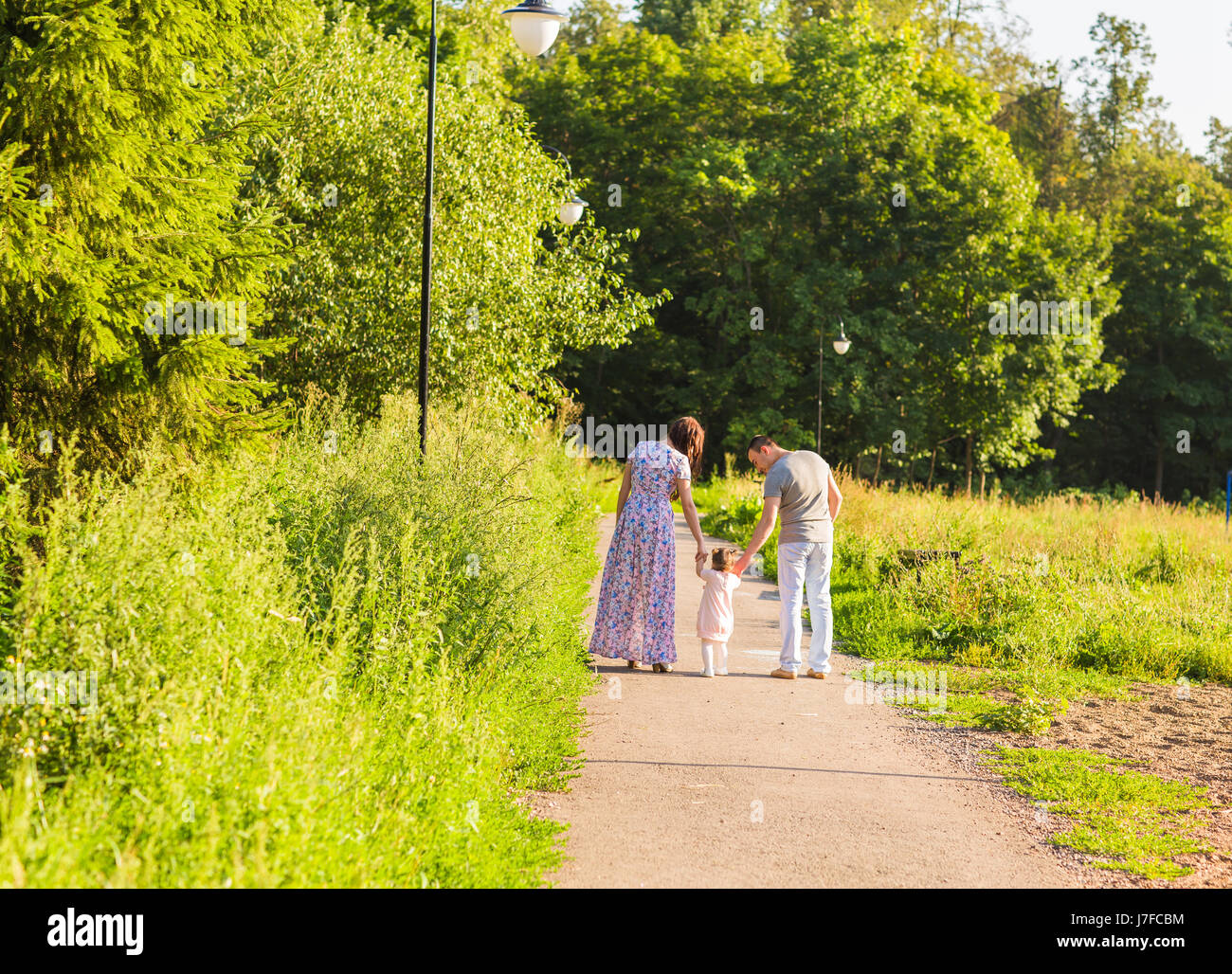 Rear View Of Family Going For Walk In Summer Countryside Stock Photo ...