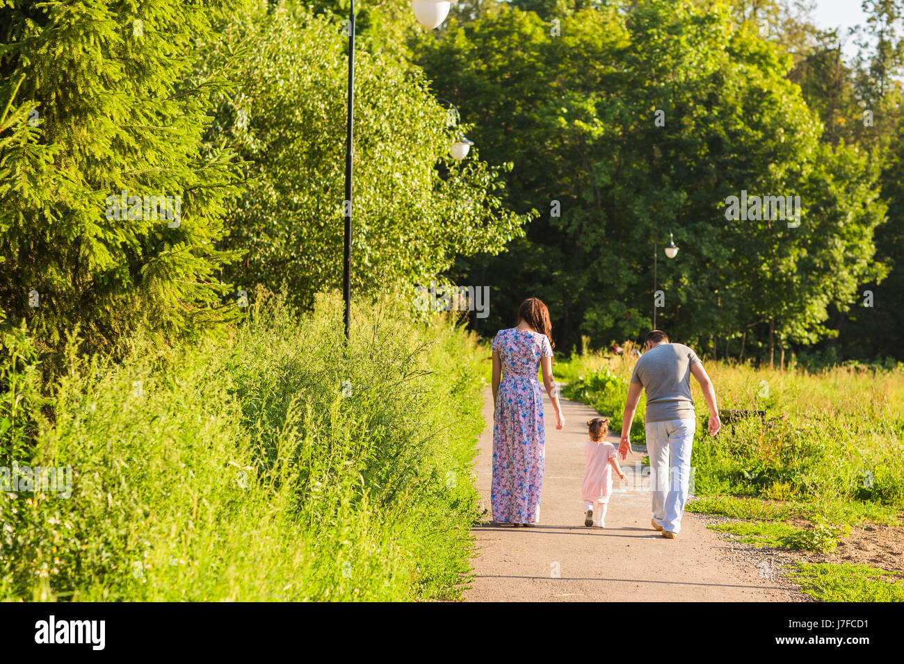 Rear View Of Family Going For Walk In Summer Countryside Stock Photo ...